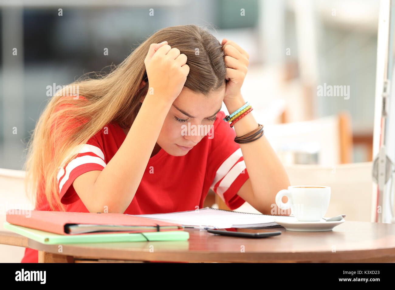 Single frustrated student girl trying to understand notes sitting in a ...