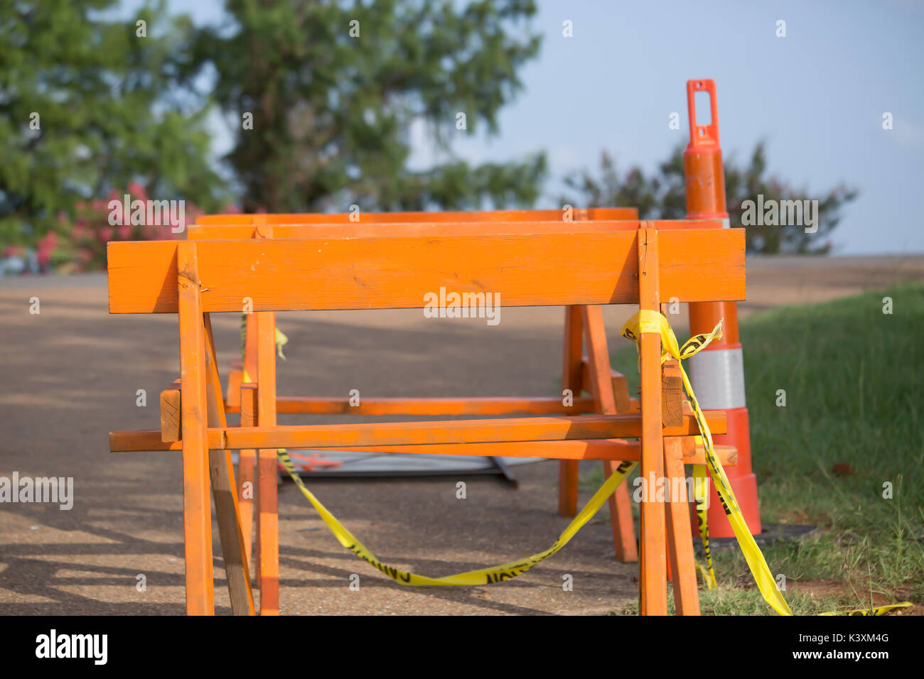 An orange road sign and cone blocking traffic Stock Photo - Alamy