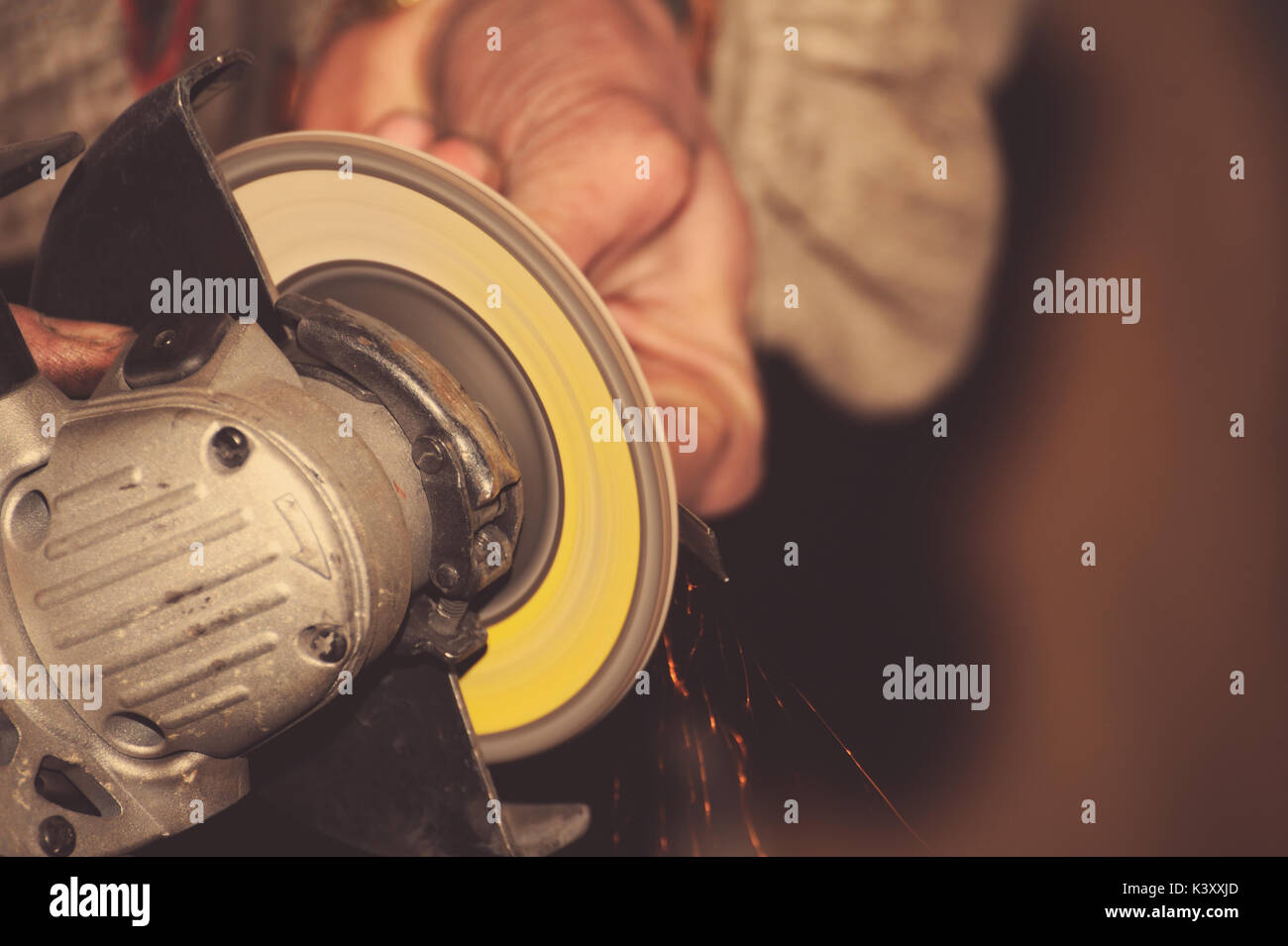 angle grinder in hand working Stock Photo - Alamy
