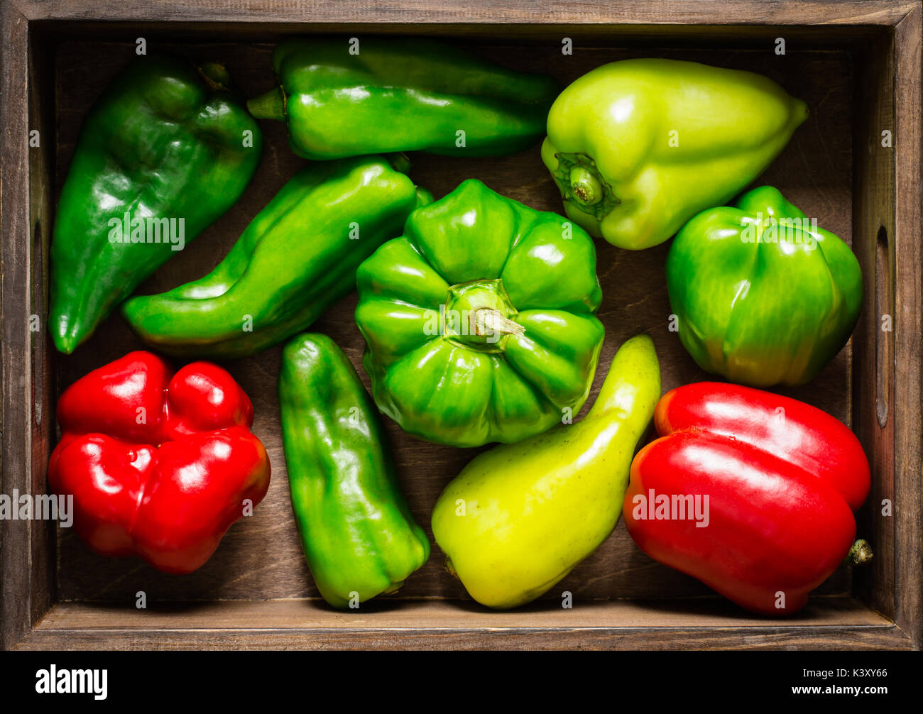 Wooden box with different red and green bell peppers closeup Stock ...