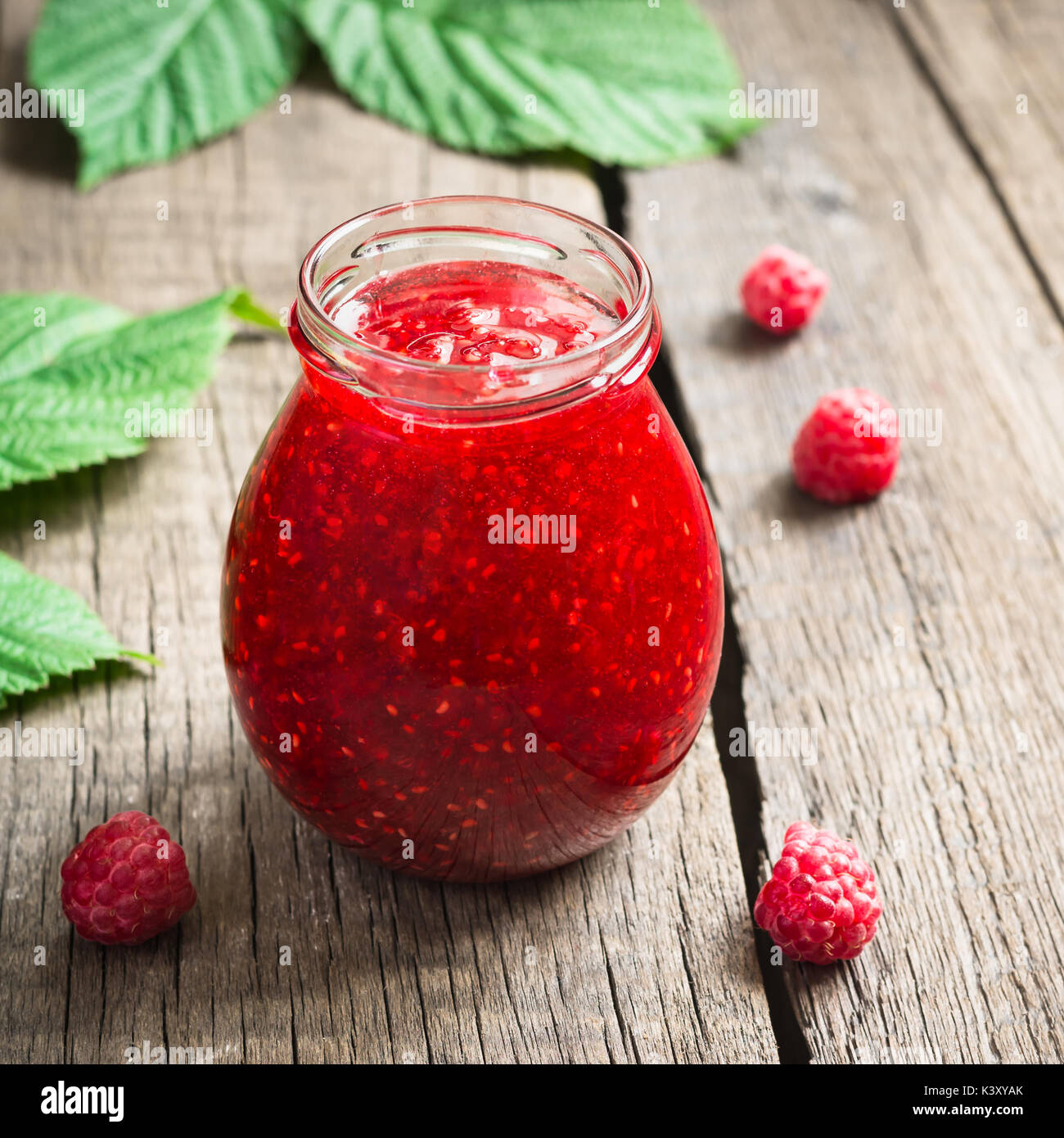 Jar with homemade raspberry jam. Ripe Berries and Leaves, Selective ...