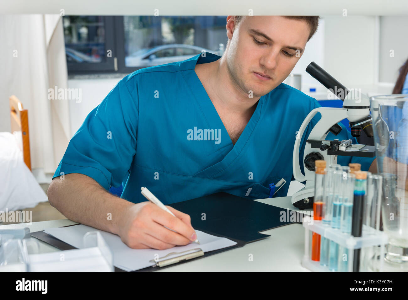 Male scientist writing notes in hi-res stock photography and images - Alamy