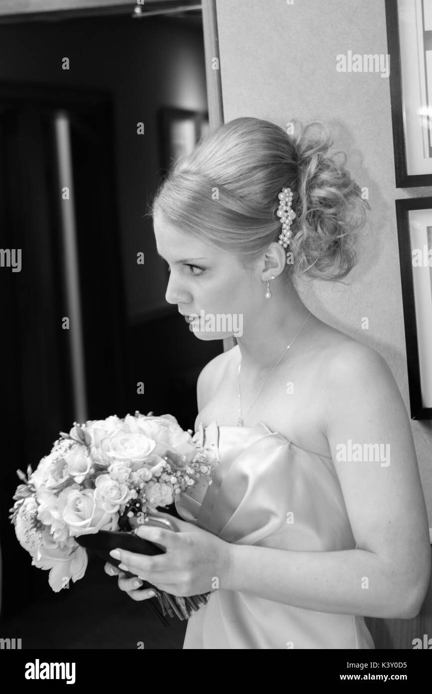 Brides maid at a wedding looking bored Stock Photo - Alamy