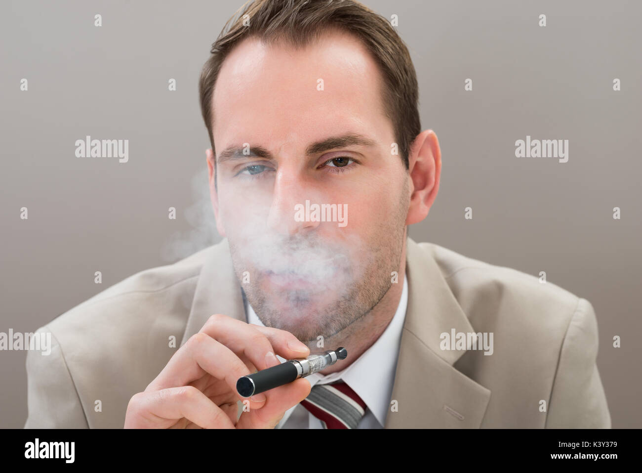 Businessman smoking cigar hi-res stock photography and images - Alamy