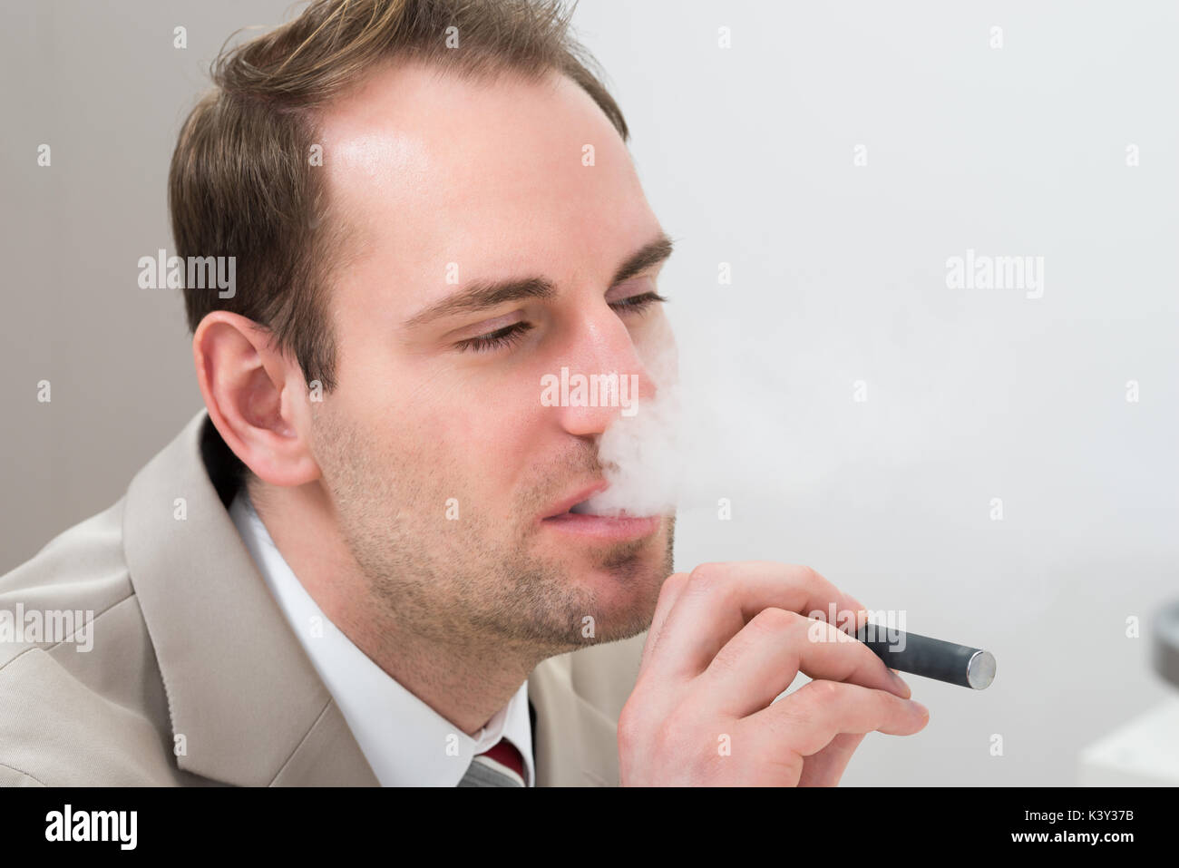 Businessman smoking cigar hi-res stock photography and images - Alamy