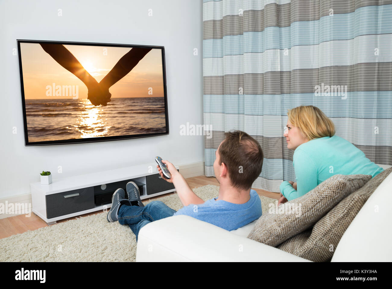 Couple Together Watching Film On Television At Home Stock Photo - Alamy