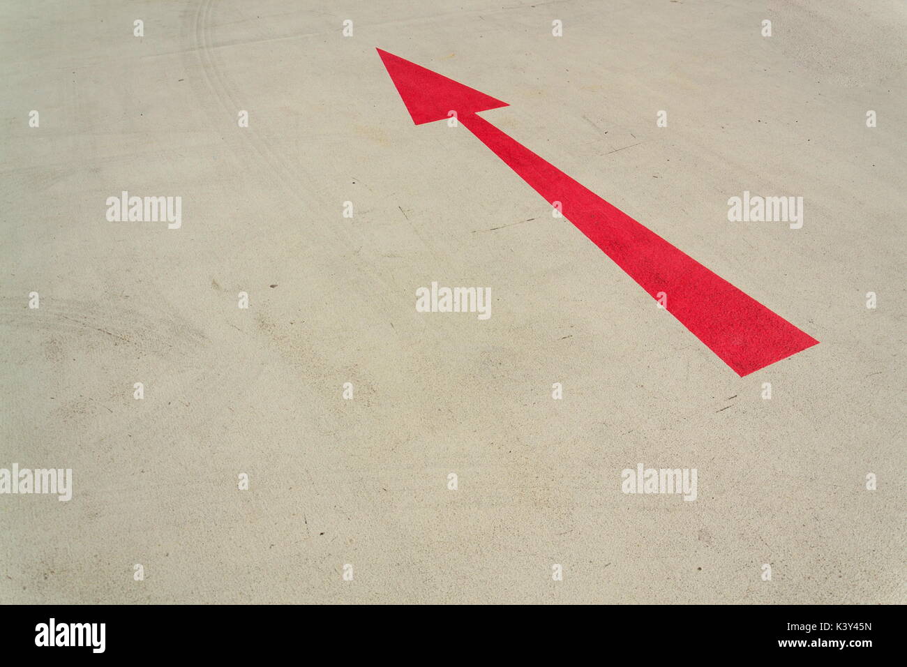 Red arrow direction sign on gray concrete road sunny day Stock Photo ...