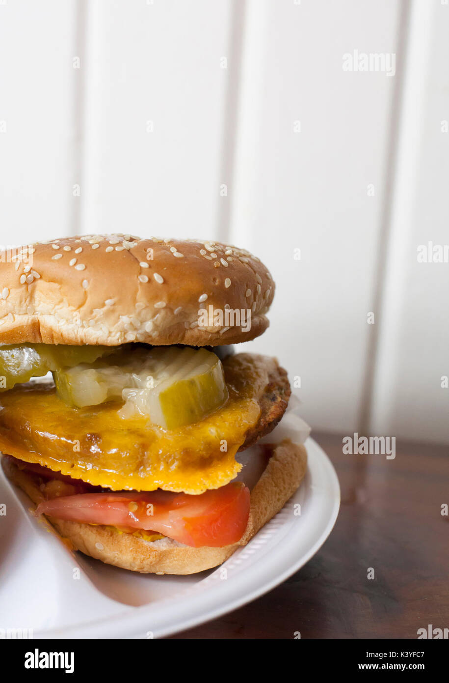 Veggie cheeseburger with pickles, tomatoes and ketchup Stock Photo - Alamy