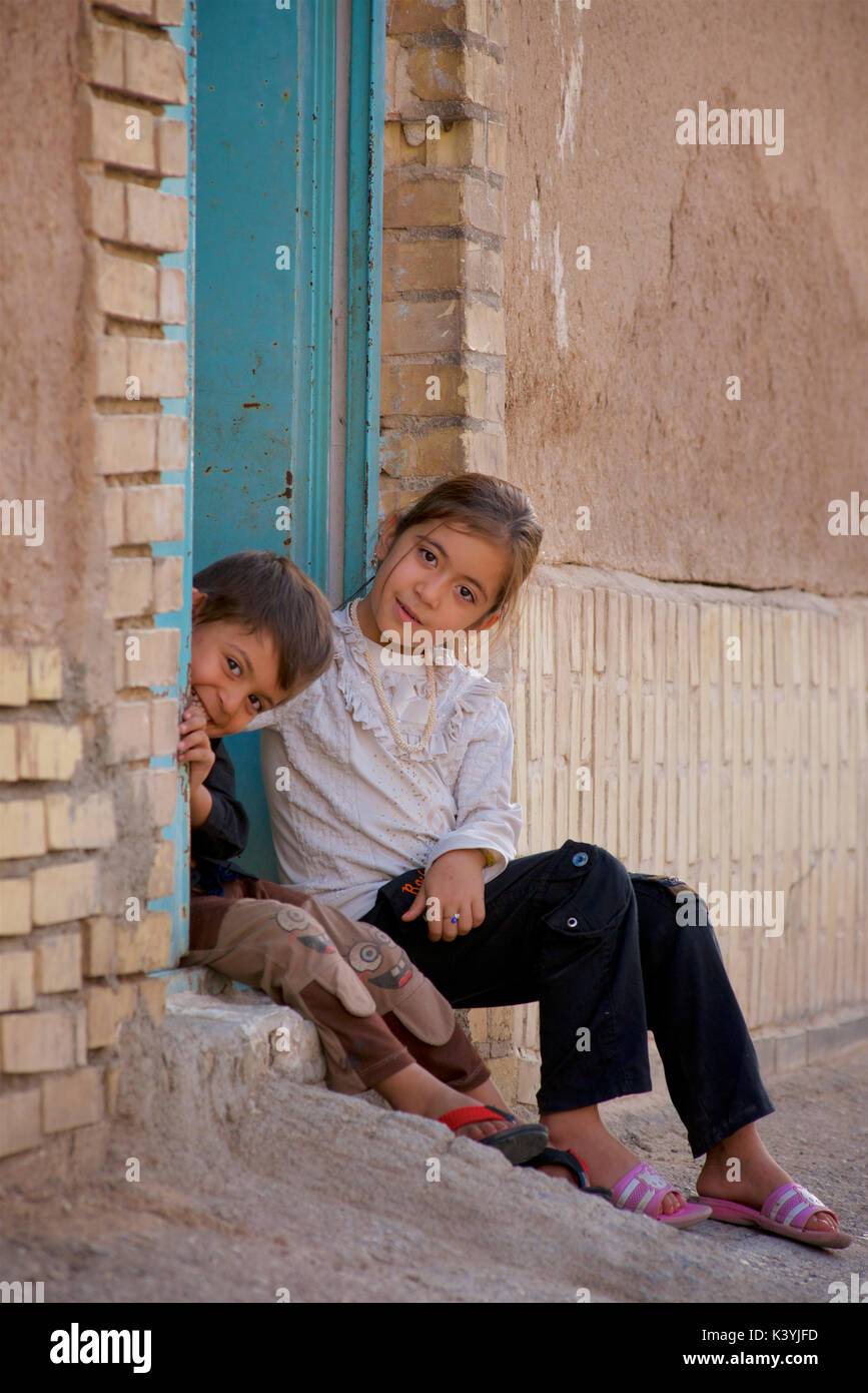 Playful Iranian children at the door to their home, Yazd, Iran Stock ...
