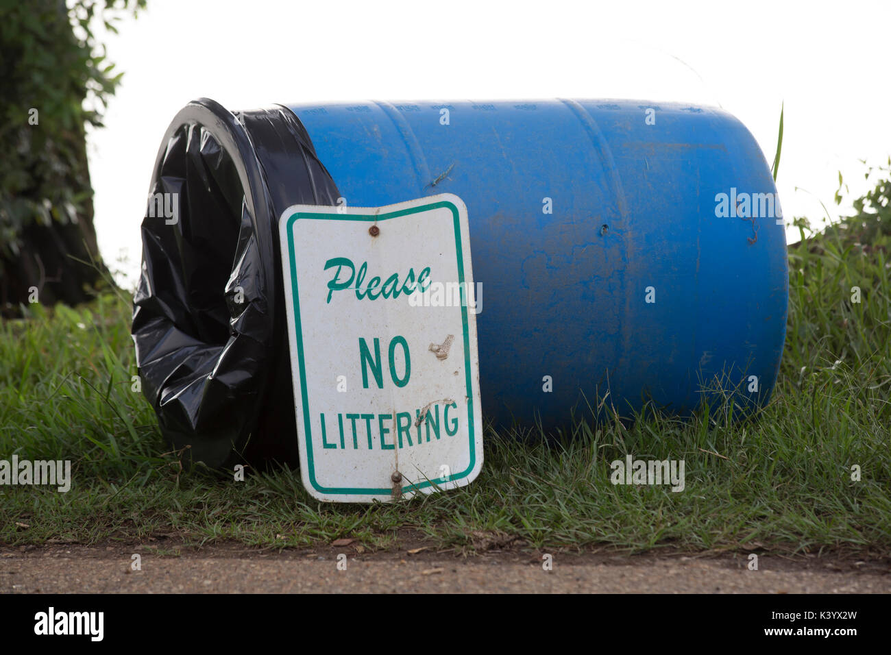 No littering sign on an overturned garbage can Stock Photo - Alamy