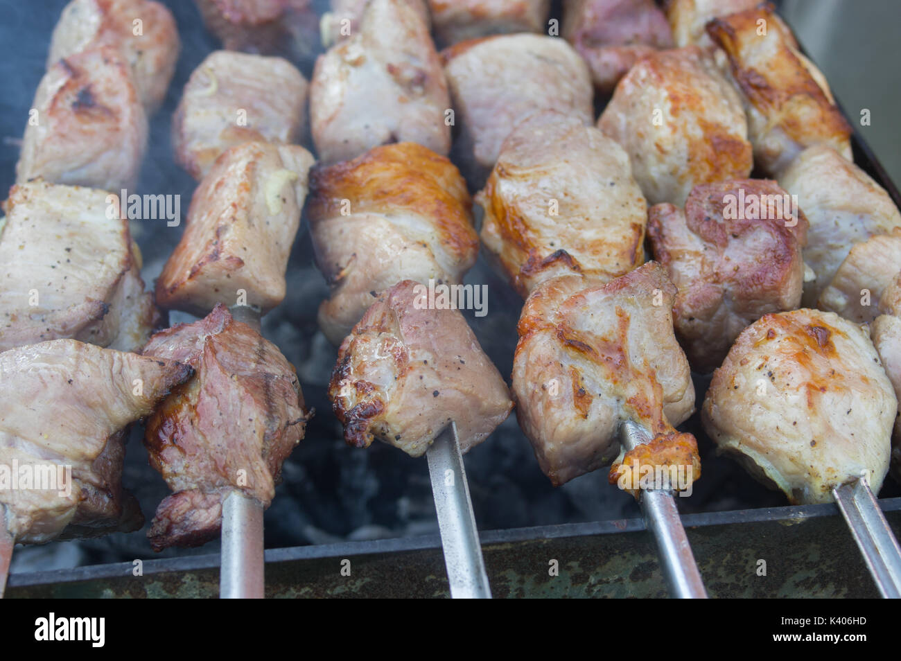 Pieces of juicy pork meat cooked outdoor on smouldering carbons Stock ...