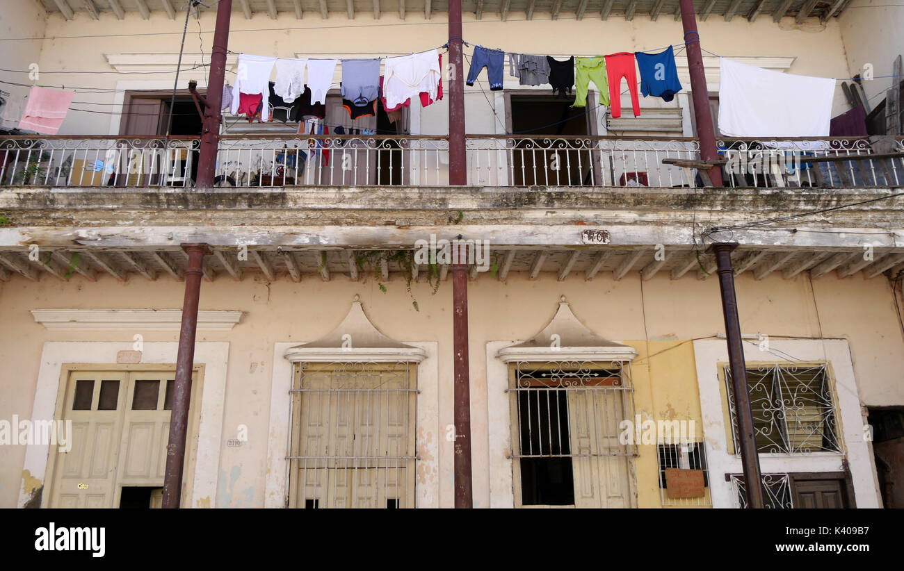 Clothes line with drying laundry on a balcony of dilapidated building ...