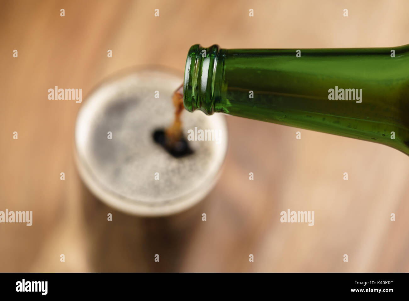 dark beer pouring in glass on wood table from above Stock Photo - Alamy