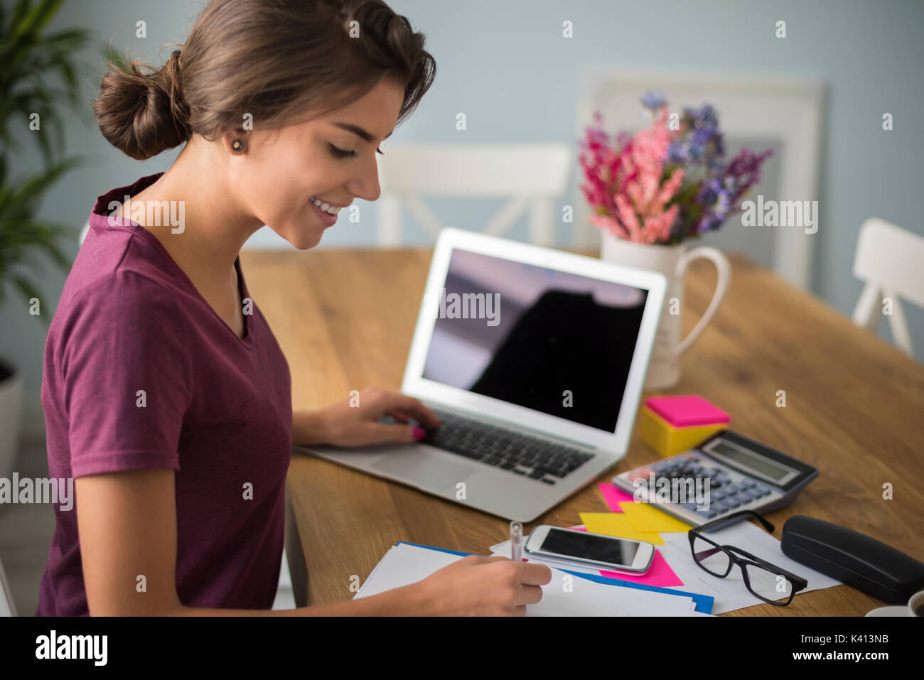Busy woman taking some important notes Stock Photo - Alamy