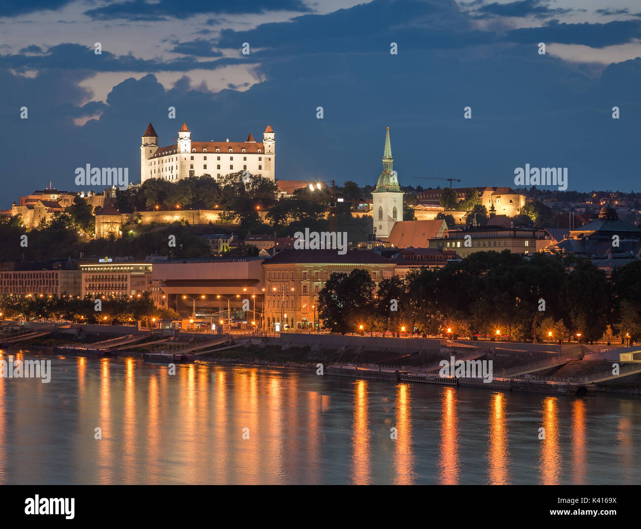 Bratislava castle at night with light reflection on the dunaj river on ...