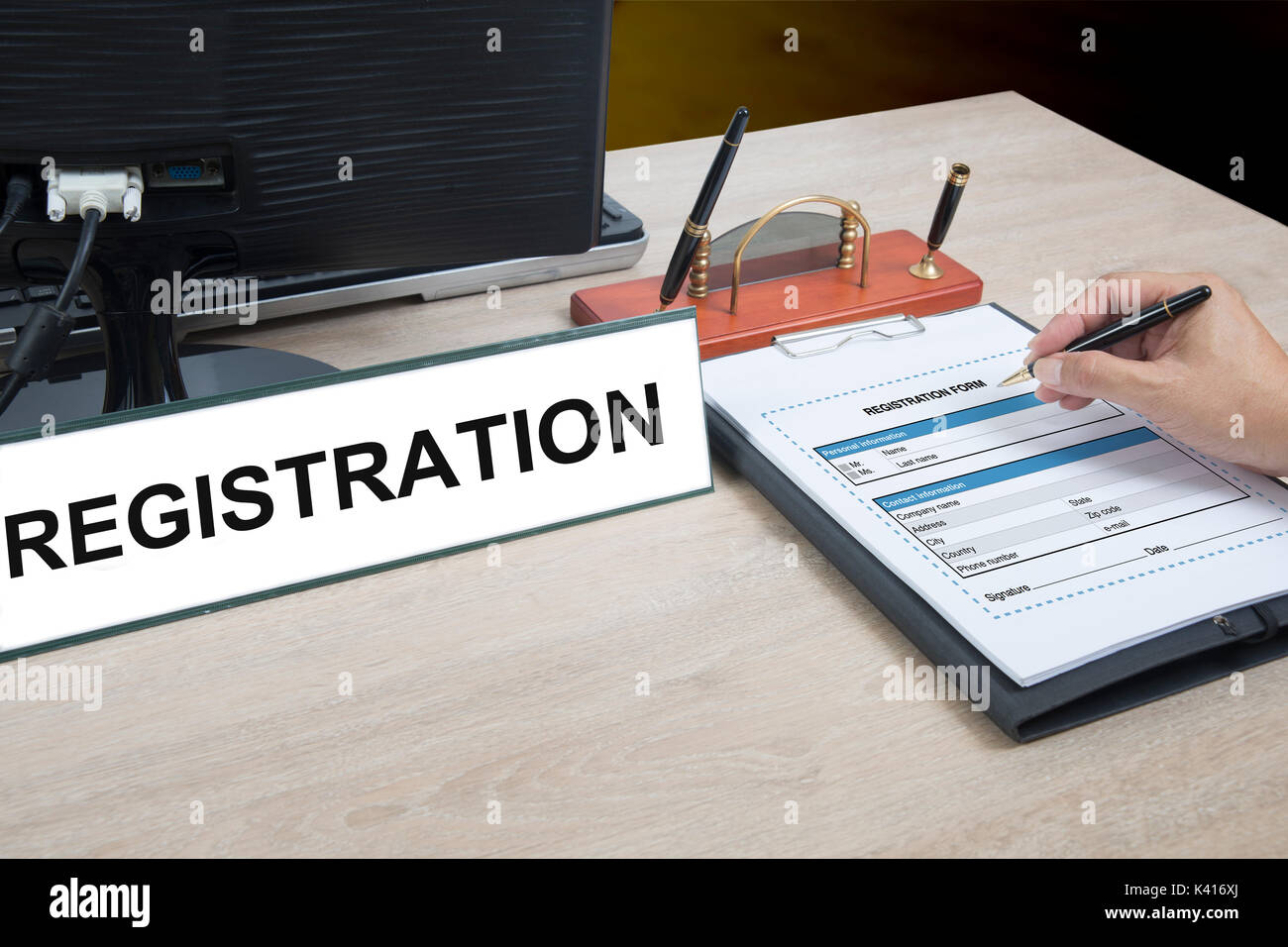 Someone writing personal information into registration form Stock Photo ...