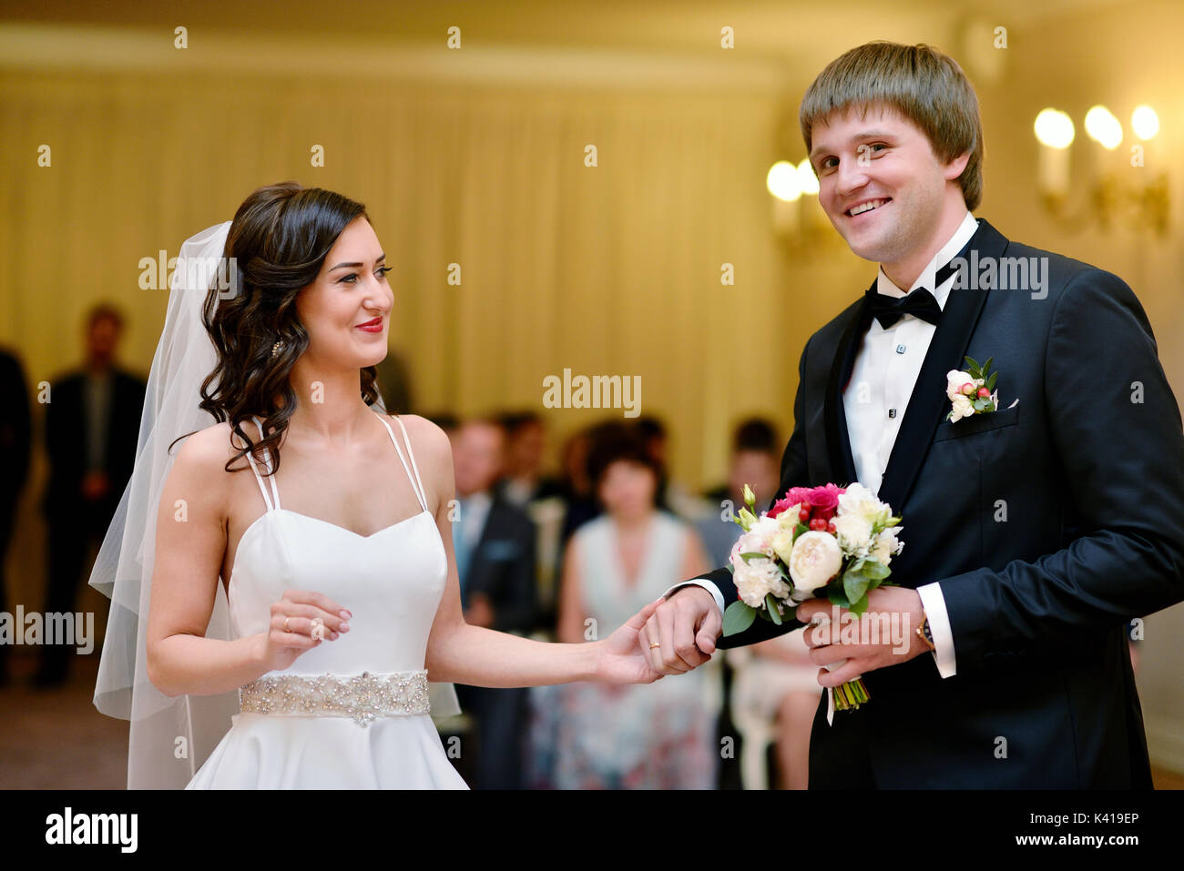 Beauty bride and handsome groom are wearing rings each other Stock ...