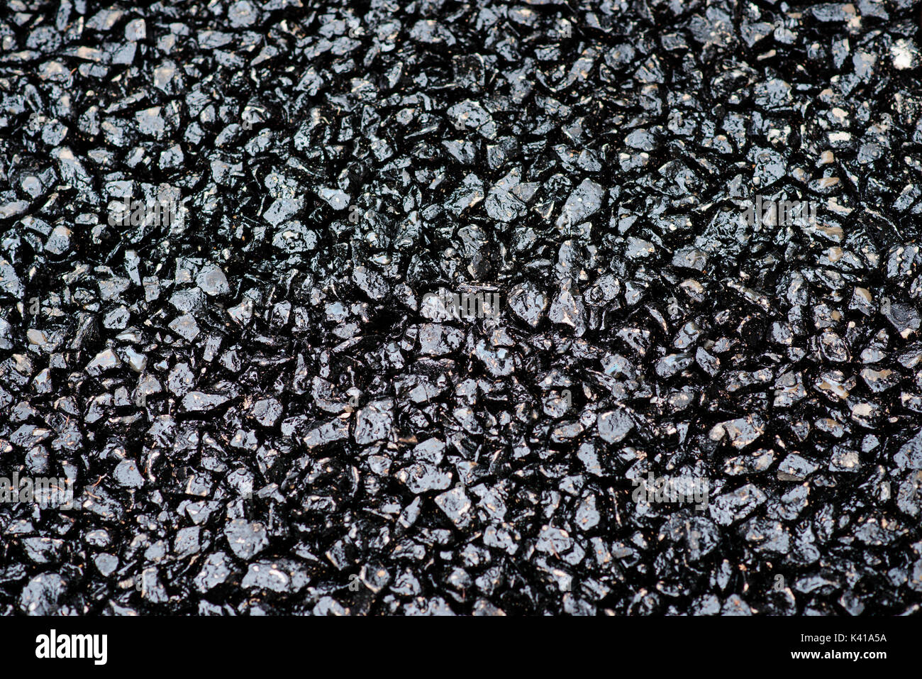 Texture of black granules of fresh asphalt that been already paved ...