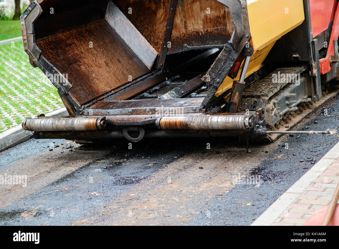 Carrying out repair works: asphalt roller stacking and pressing hot lay ...