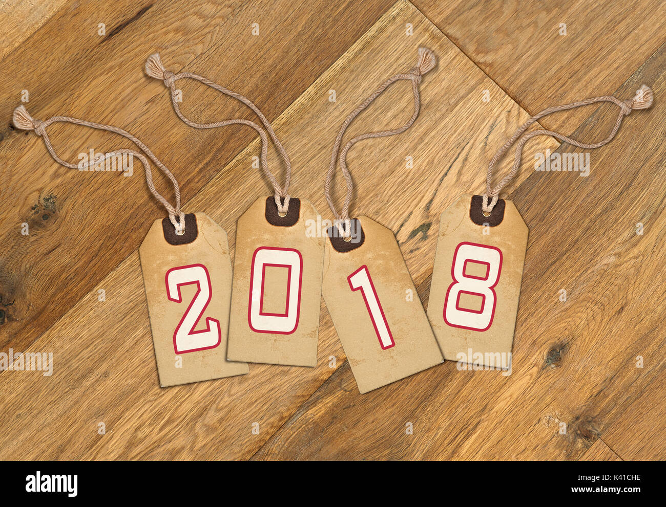 Textured tag with 2018 tied with brown string on wooden floor Stock ...