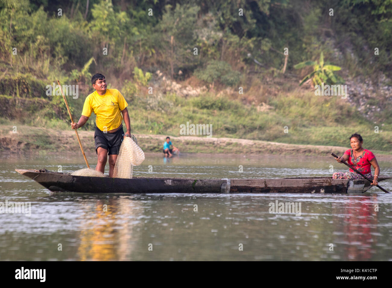 Local indigenous villagers fishing in dugout canoe in Narayani-Rapti ...