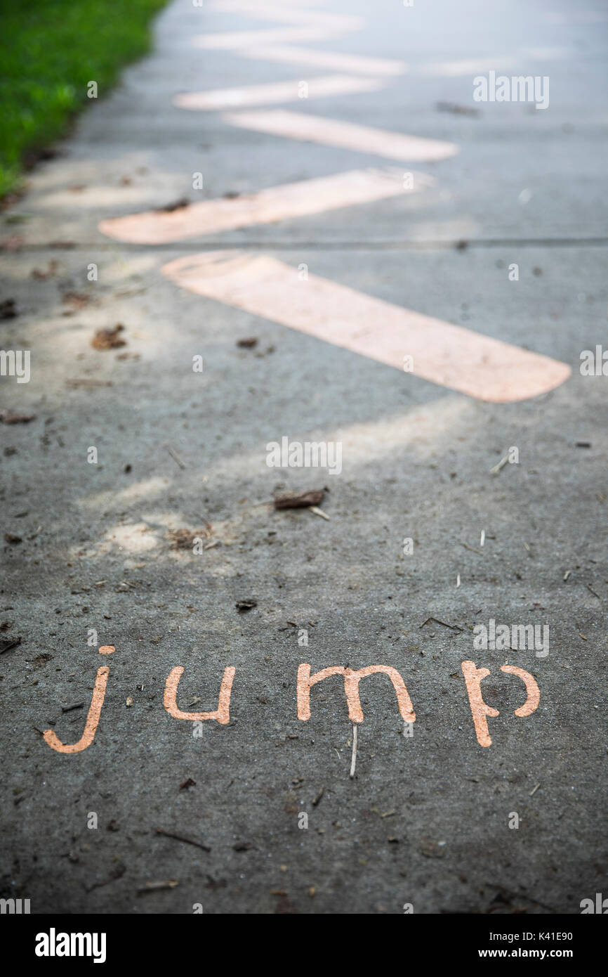 The word jump painted on a concrete sidewalk Stock Photo - Alamy