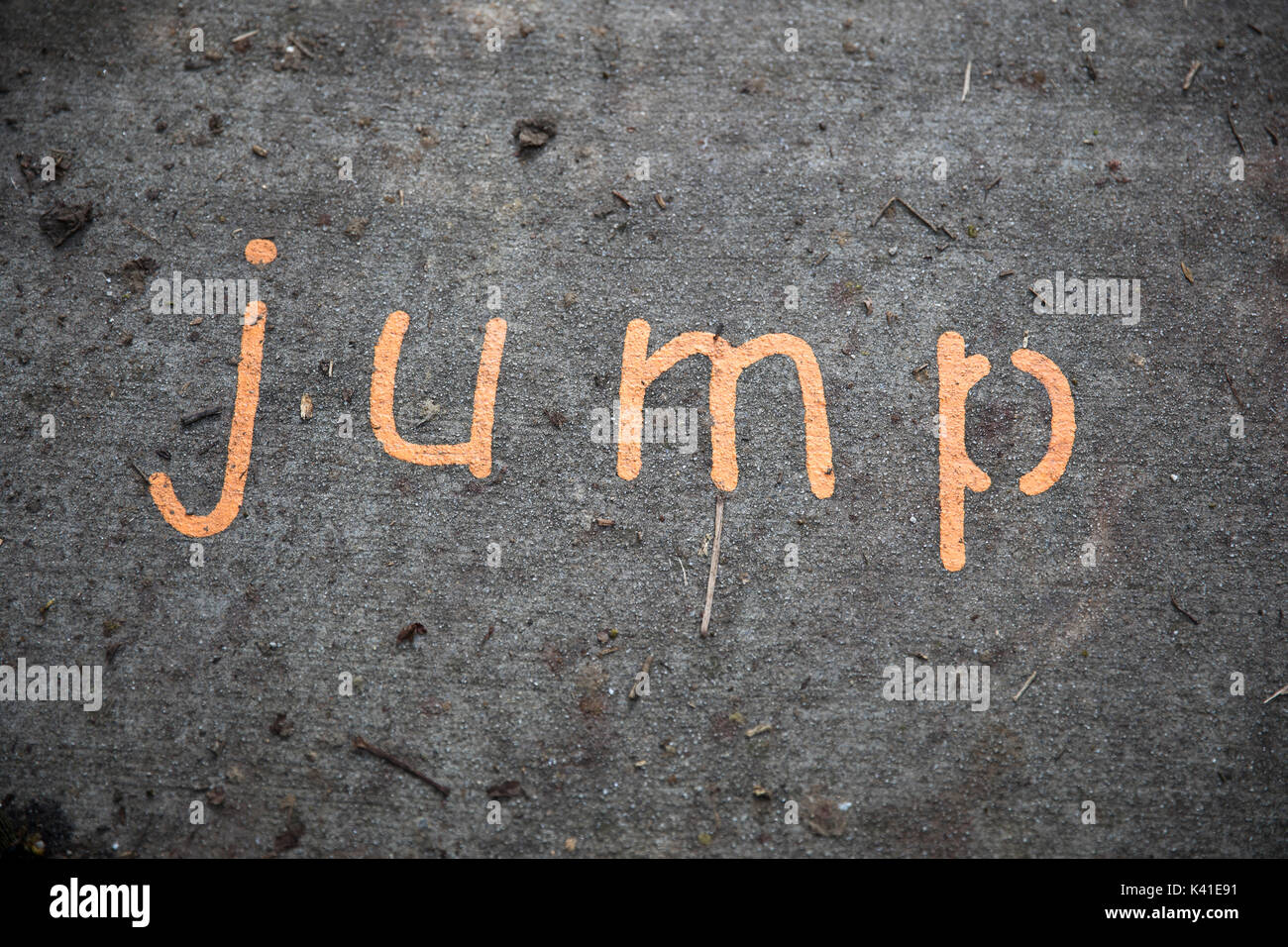 The word jump painted on a concrete sidewalk Stock Photo - Alamy