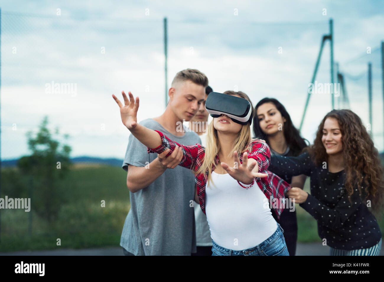 Attractive teenagers on playground. Girl with VR glasses Stock Photo ...