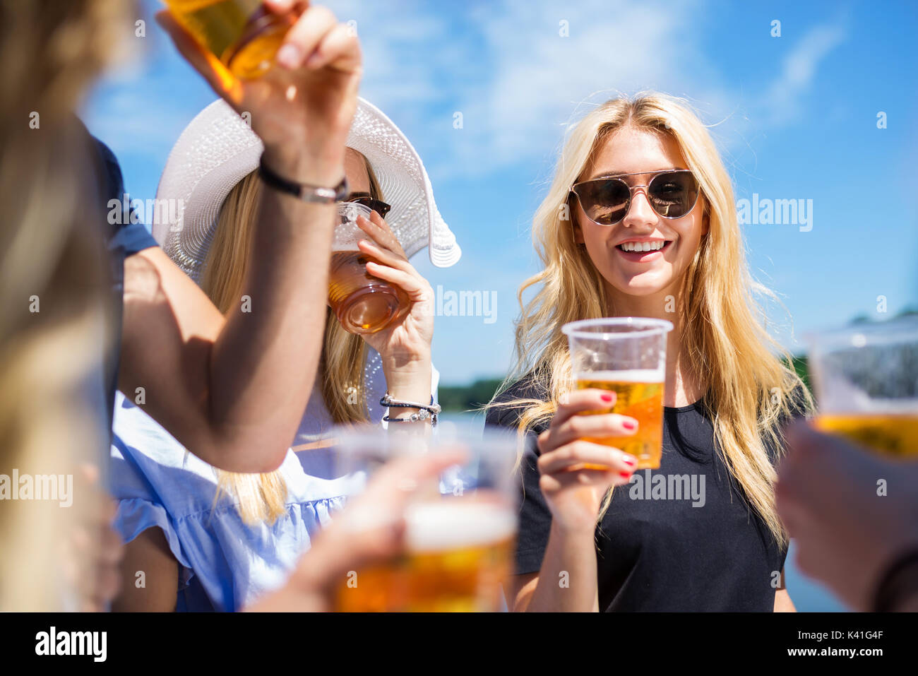 Blonde girl drinking beer hi-res stock photography and images - Alamy