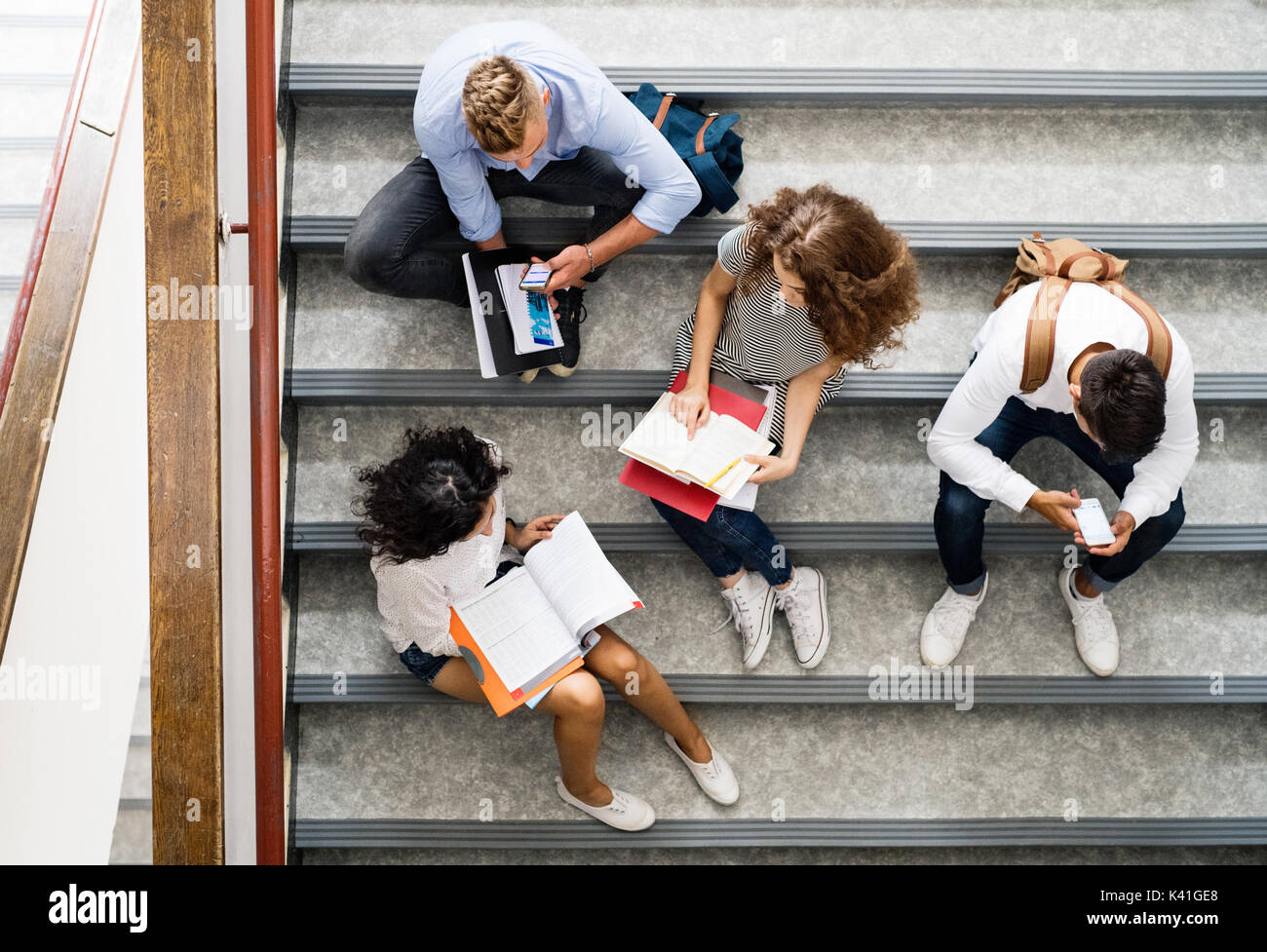 Teenage students on stairs in high school Stock Photo - Alamy