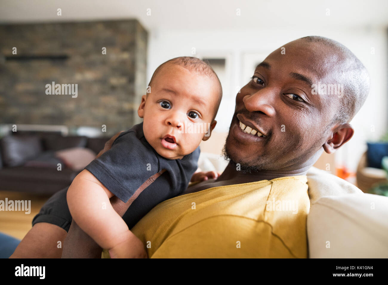 Father carrying child in arms hi-res stock photography and images - Alamy