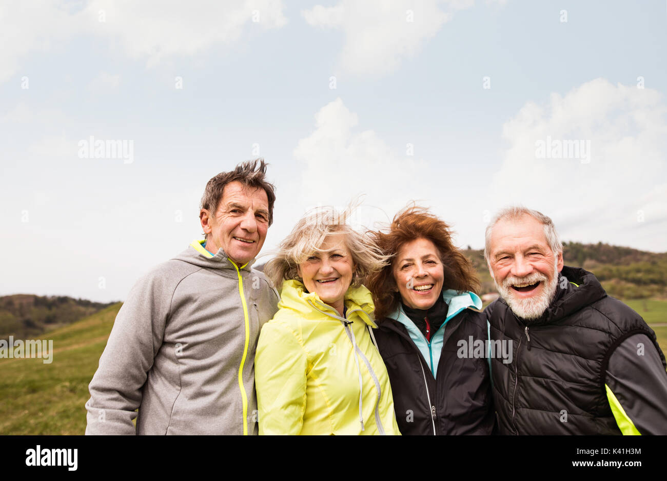 Group of senior runners outdoors, resting and hugging Stock Photo - Alamy