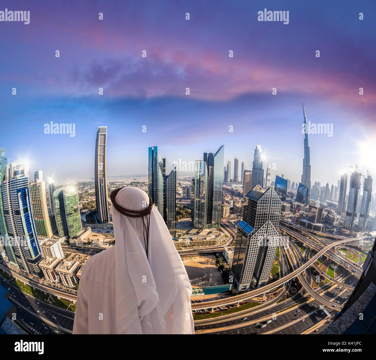 Arabian man watching cityscape of Dubai with modern futuristic ...