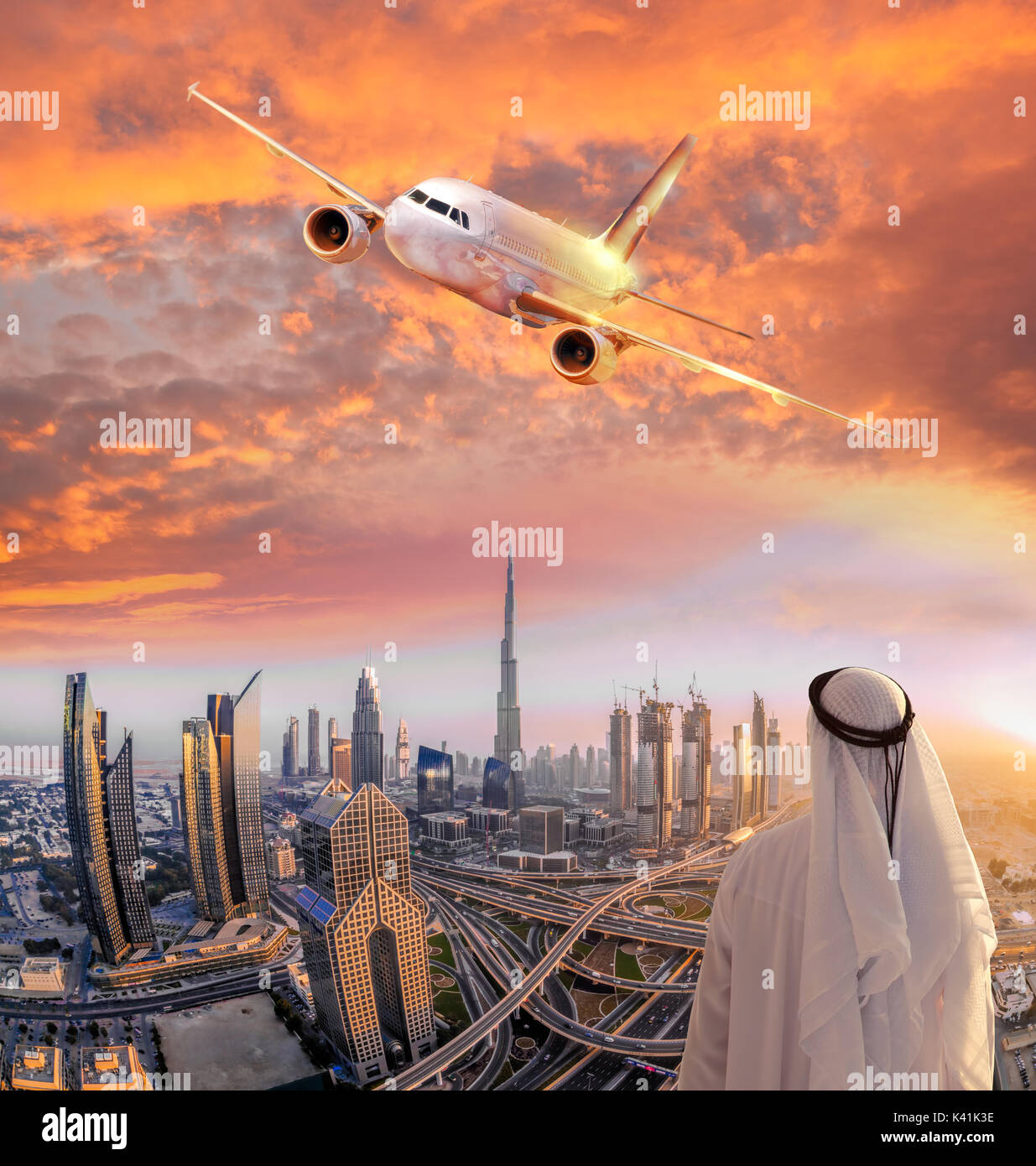 Arabian man with airplane flying over Dubai against colorful sunset in ...