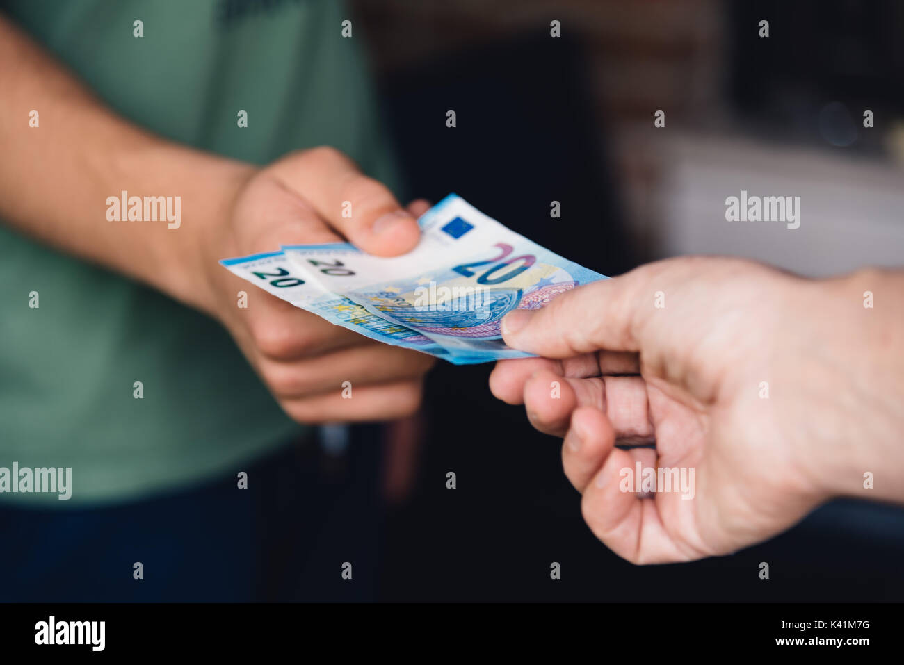 Hand of woman is giving euro money to a young man Stock Photo - Alamy