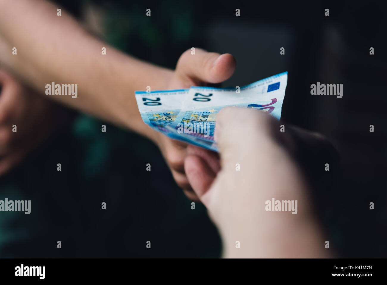 Hand of woman is giving euro money to a young man Stock Photo - Alamy