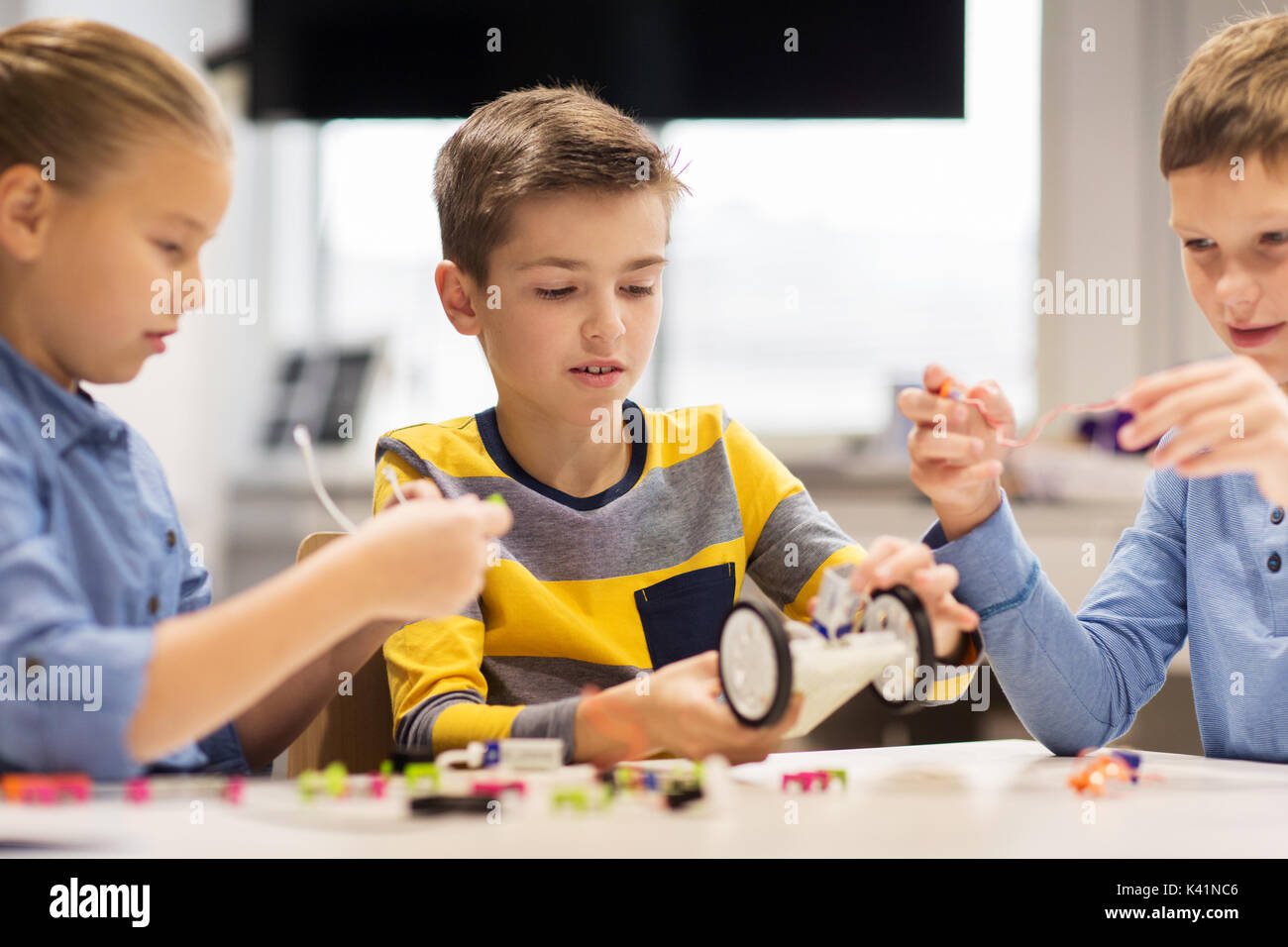 happy children building robots at robotics school Stock Photo - Alamy