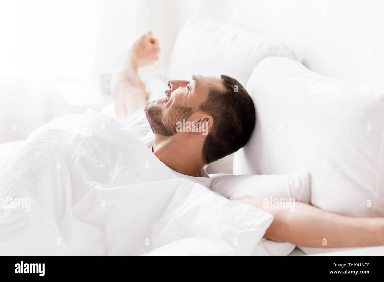 man lying in bed at home Stock Photo - Alamy