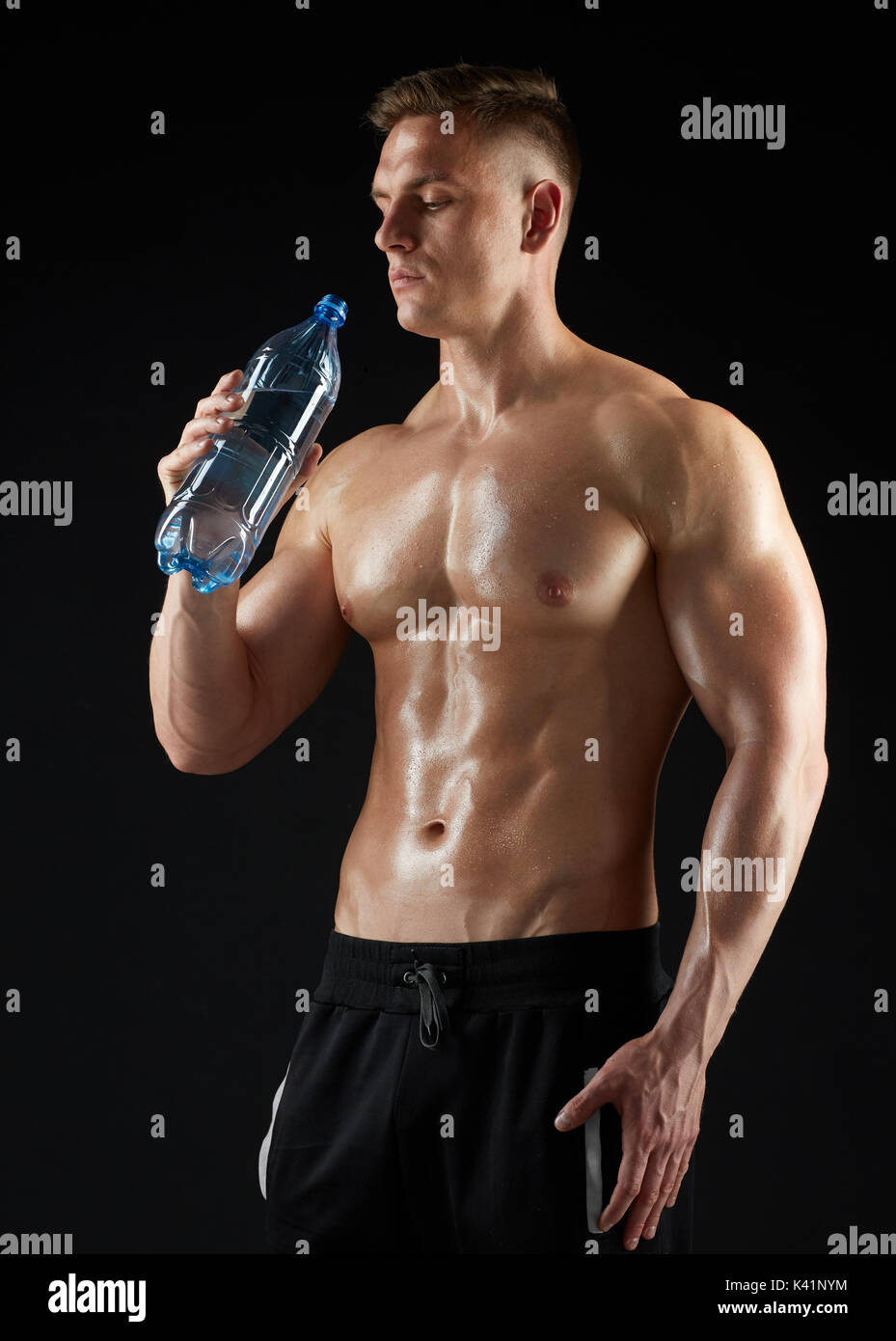 young man or bodybuilder with bottle of water Stock Photo - Alamy