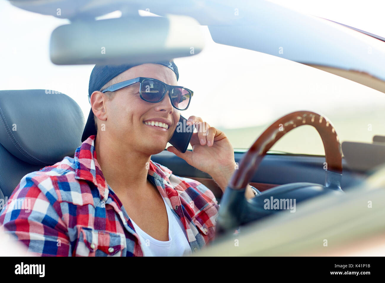 young man driving car and calling on smartphone Stock Photo - Alamy