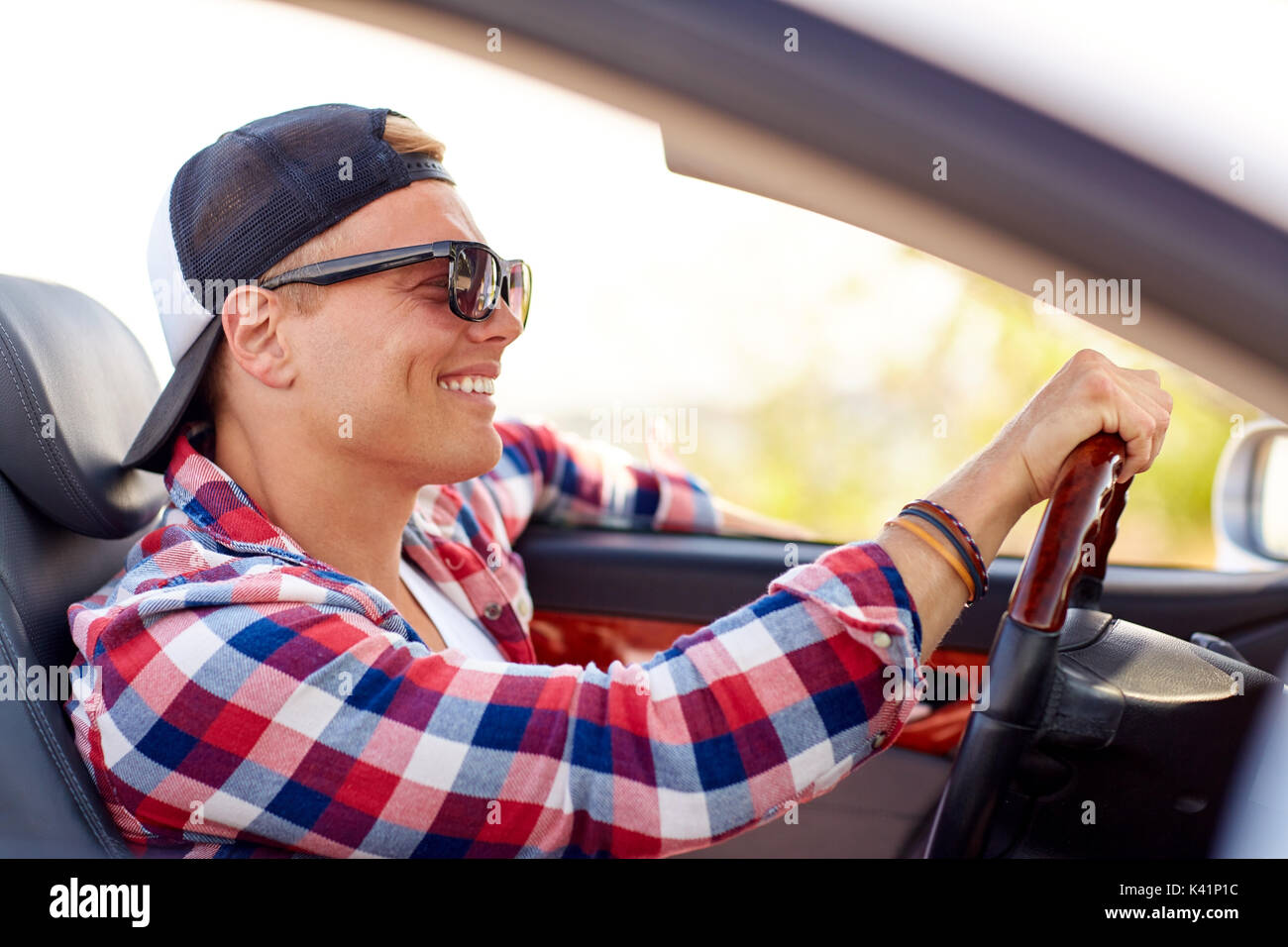 happy young man in shades driving convertible car Stock Photo - Alamy