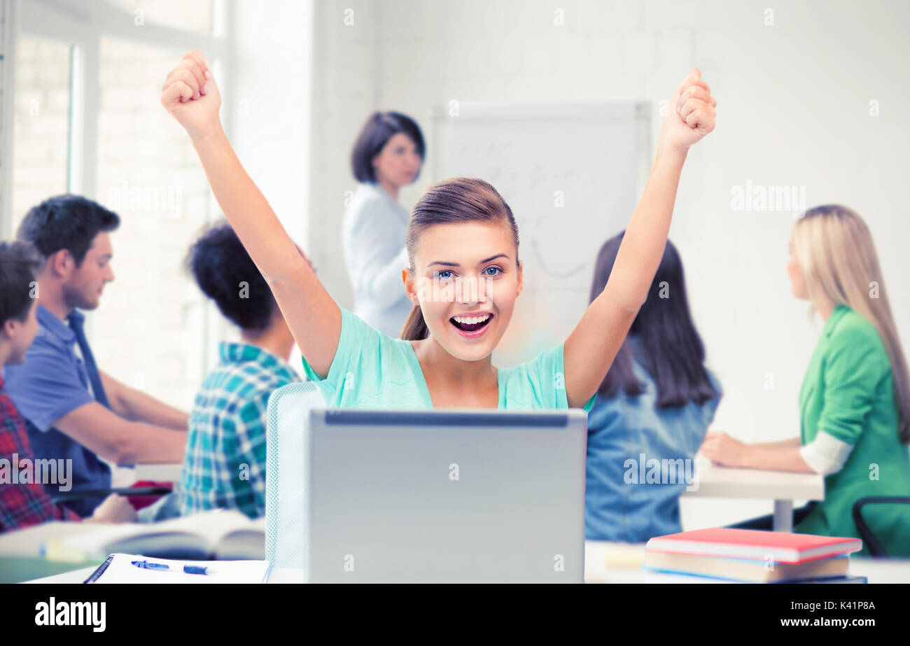 happy student girl with laptop at school Stock Photo - Alamy