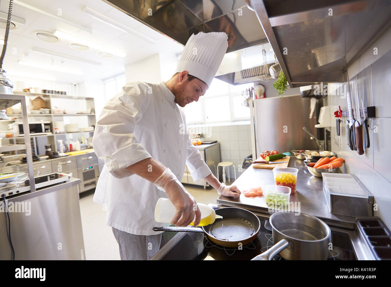happy male chef cooking food at restaurant kitchen Stock Photo - Alamy