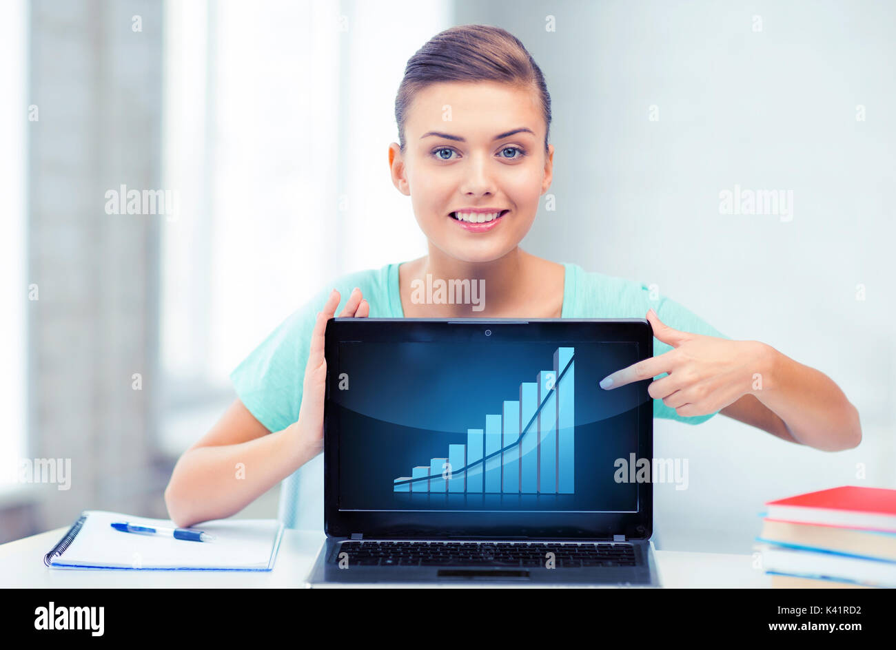 student showing laptop with graph Stock Photo - Alamy