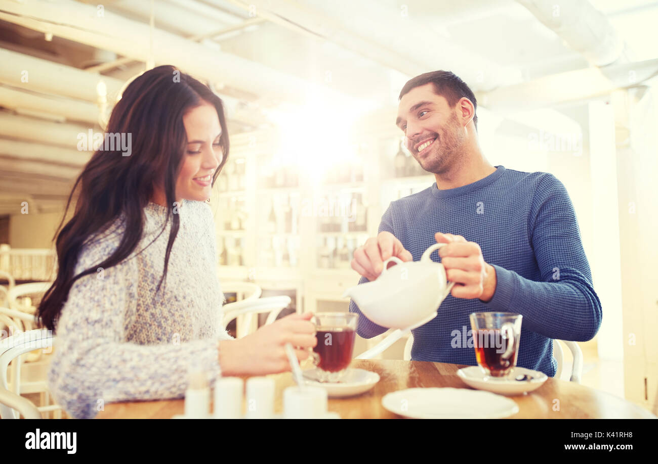 happy couple drinking tea at cafe Stock Photo - Alamy