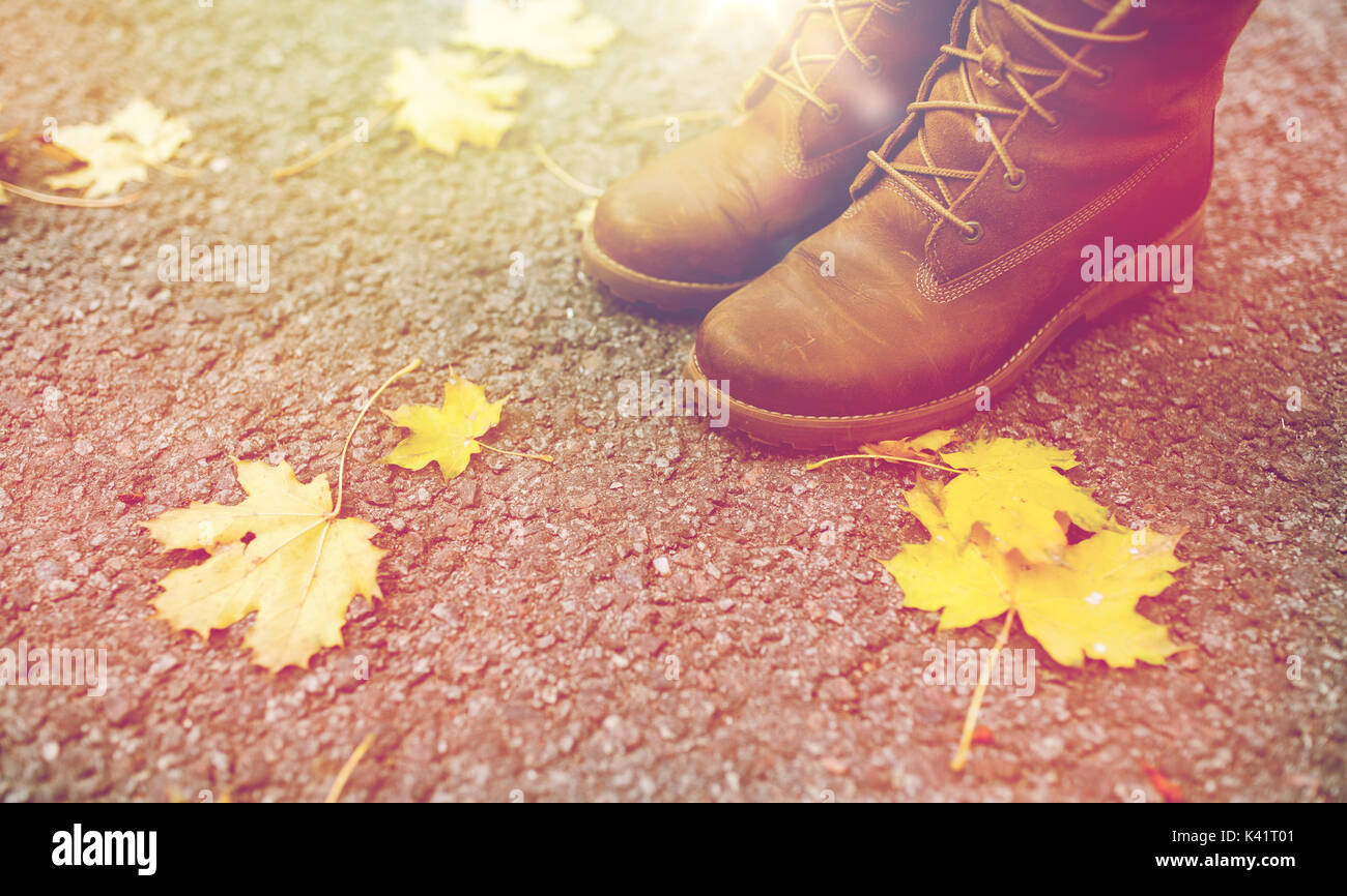 female feet in boots and autumn leaves Stock Photo - Alamy