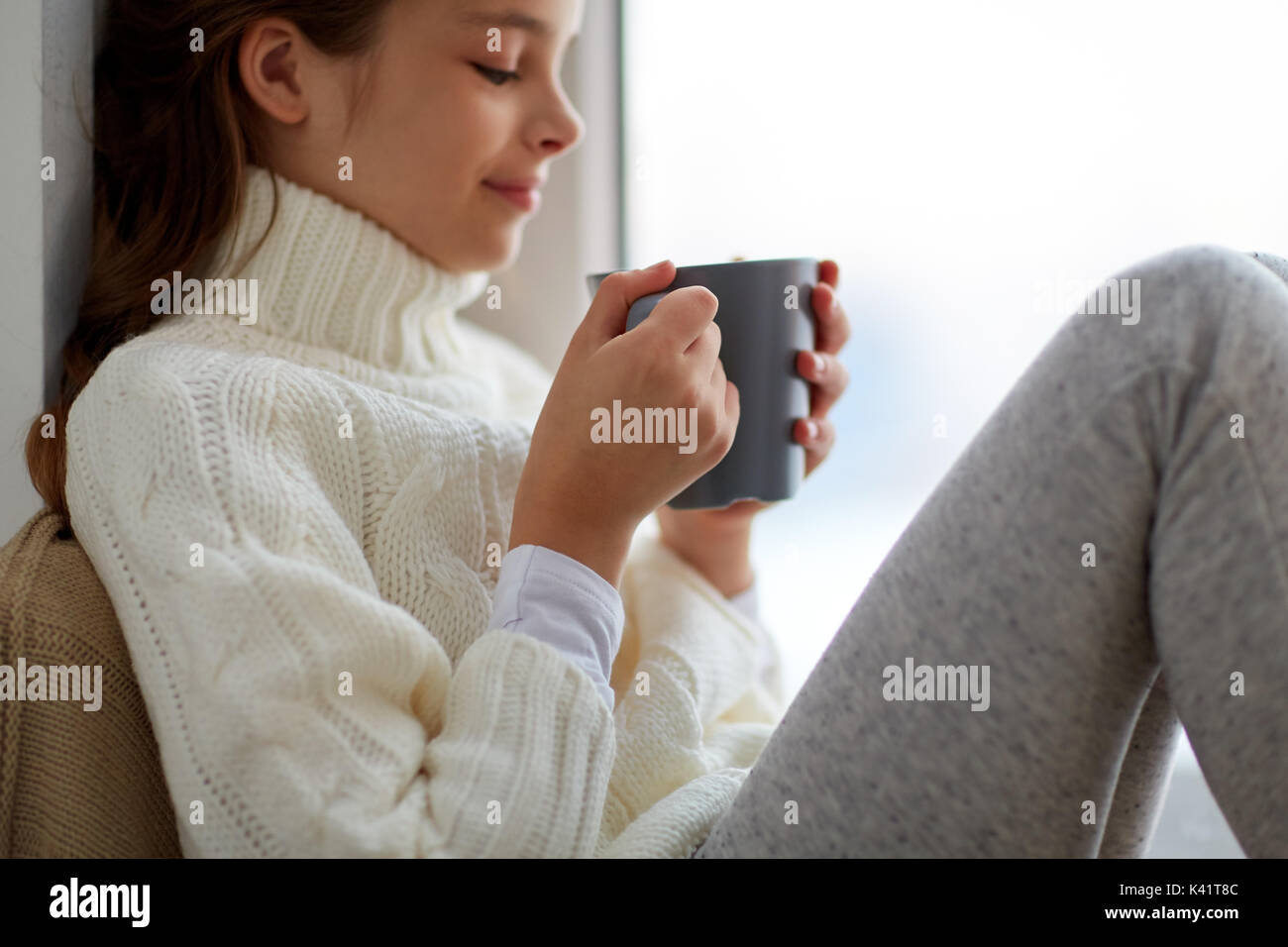 girl with tea mug sitting at home window Stock Photo - Alamy
