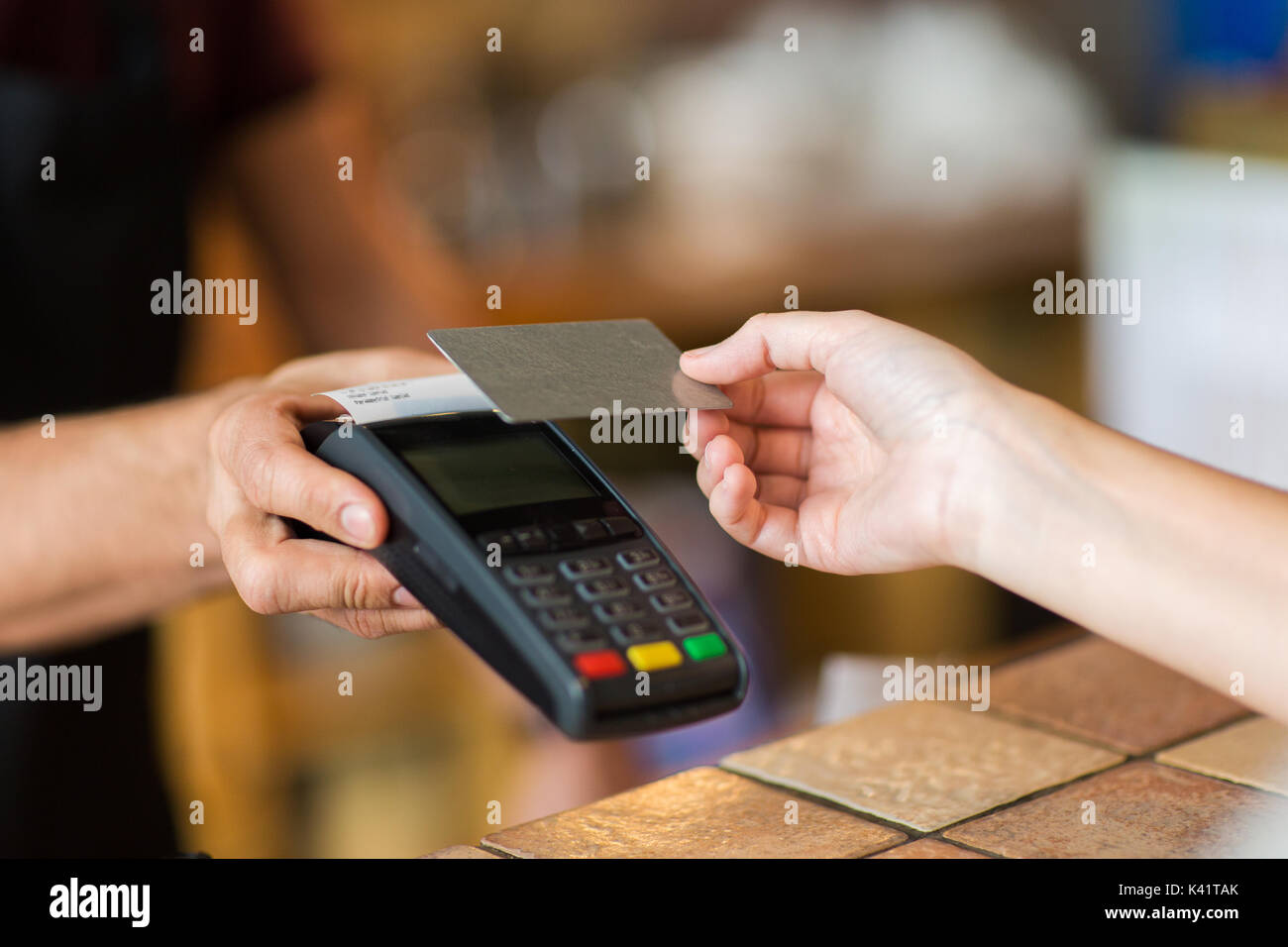 hands with payment terminal and credit card Stock Photo - Alamy
