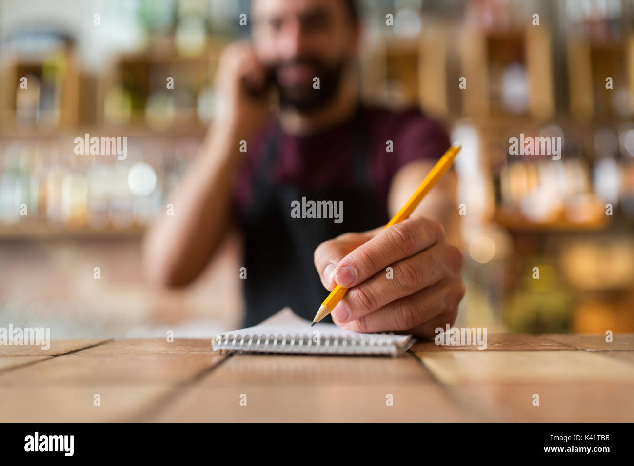 bartender with notebook and pencil at bar Stock Photo - Alamy