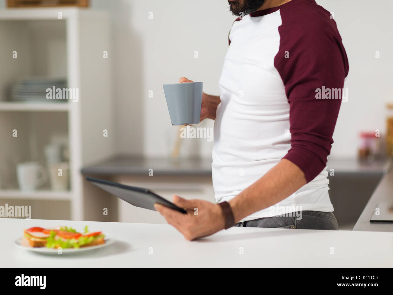 $young man eating breakfast browsing hi-res stock photography and ...